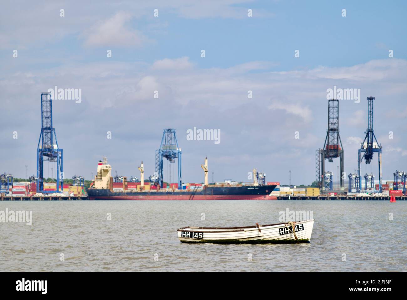 Rowing boat with the container ship Maersk Vigo docked at The Port of ...