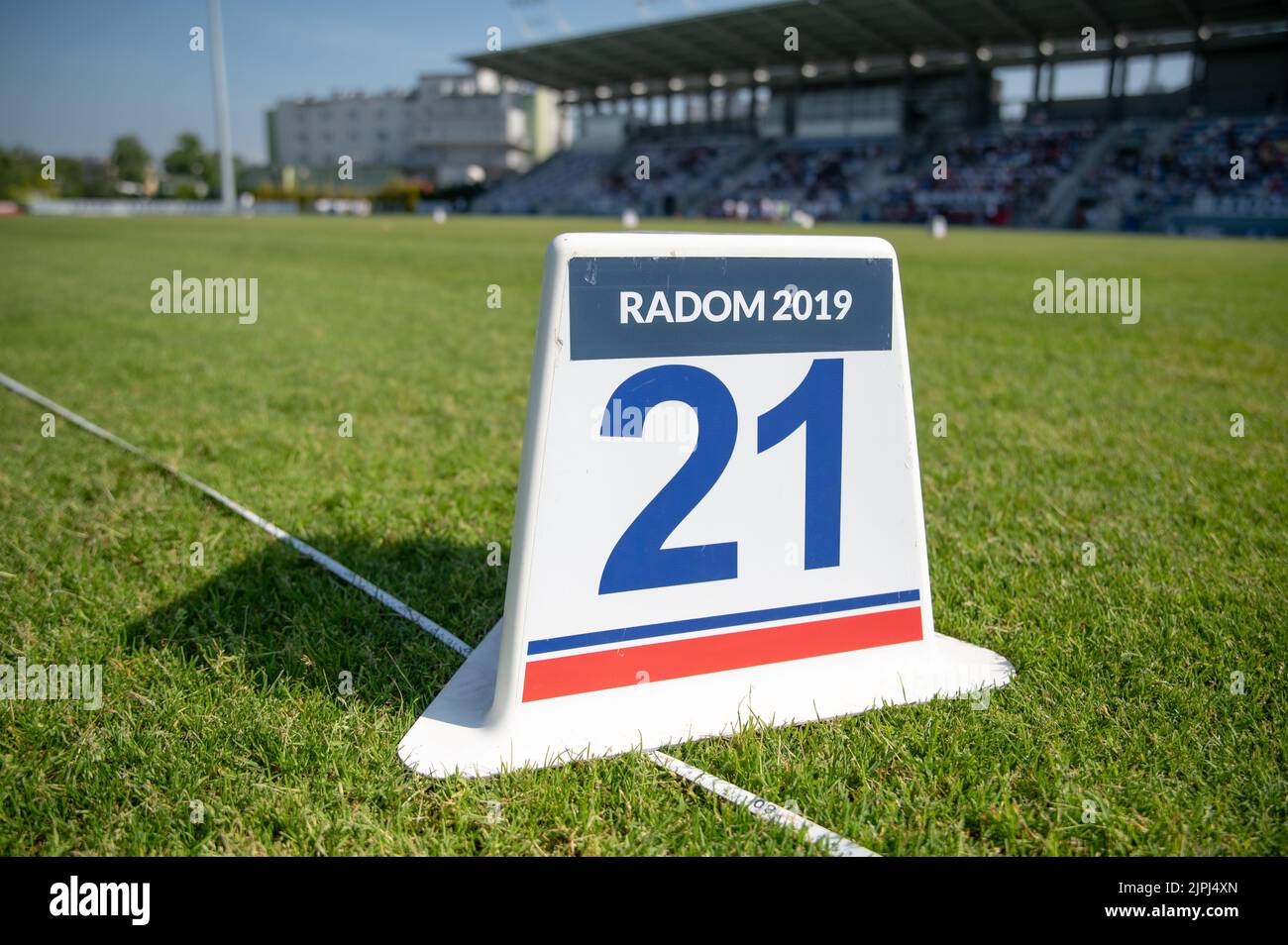 A selective focus shot of a sign in a football station with a blurred ...