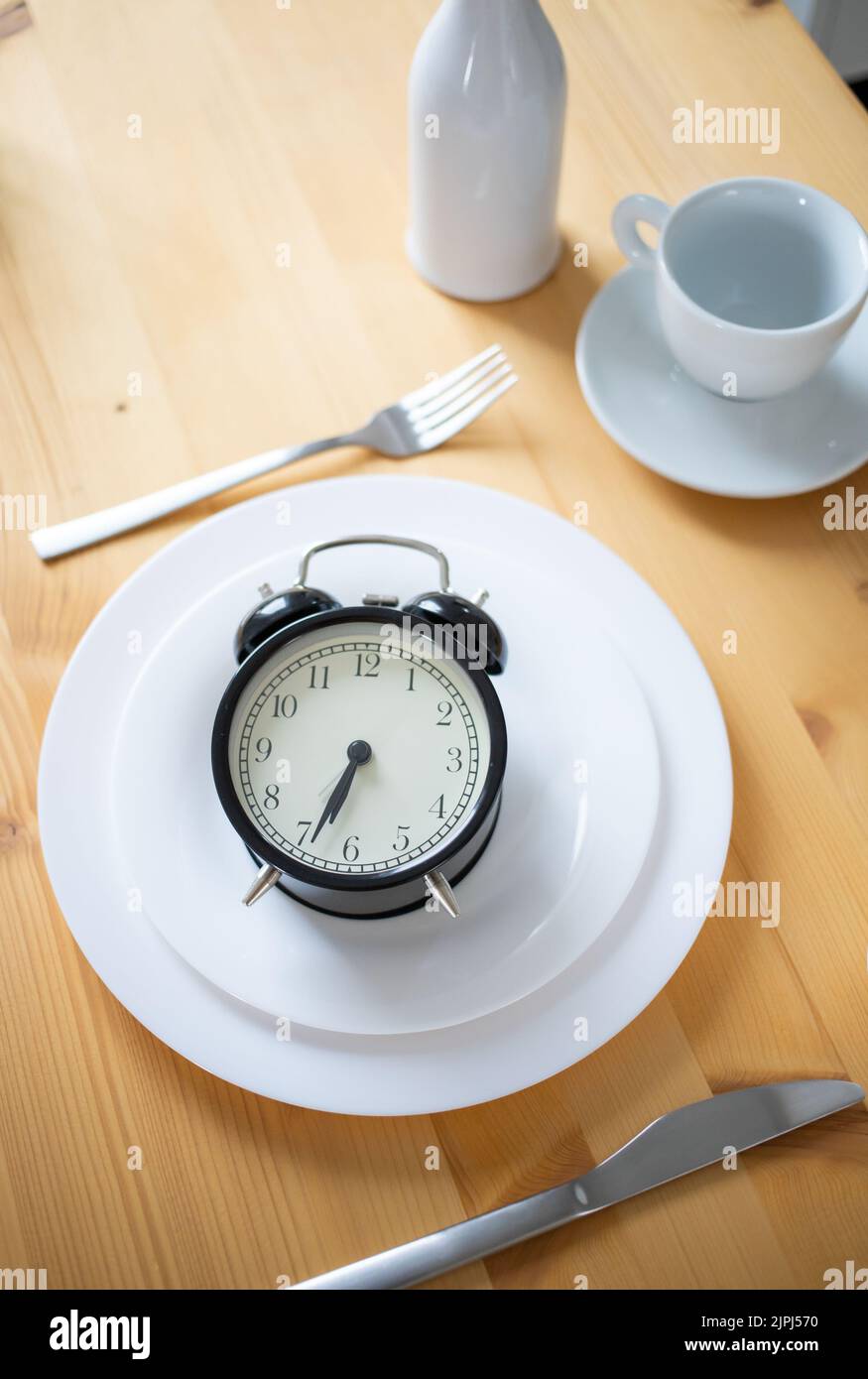 intermittent fasting concept alarm clock on kitchen table Stock Photo ...