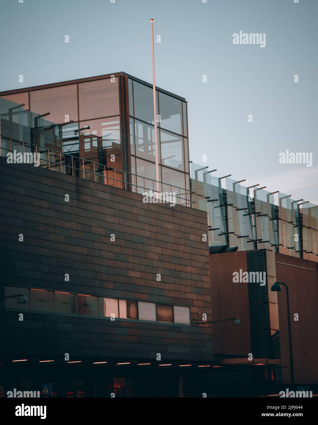 A modern abstract building with big glass windows and brick wall Stock ...