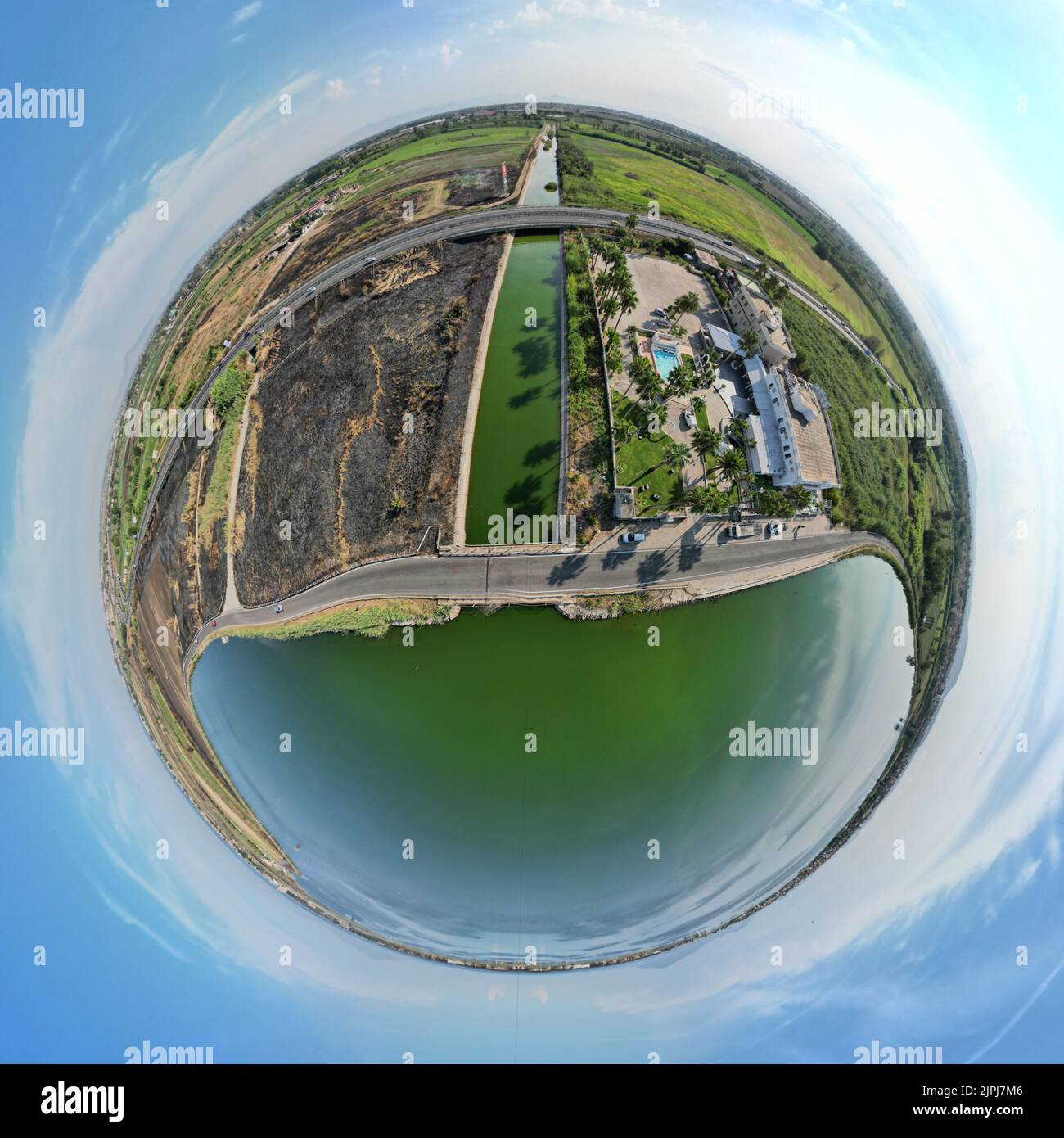 A 360-degree shot of Lake Patria surrounded with fields, a park and sun ...
