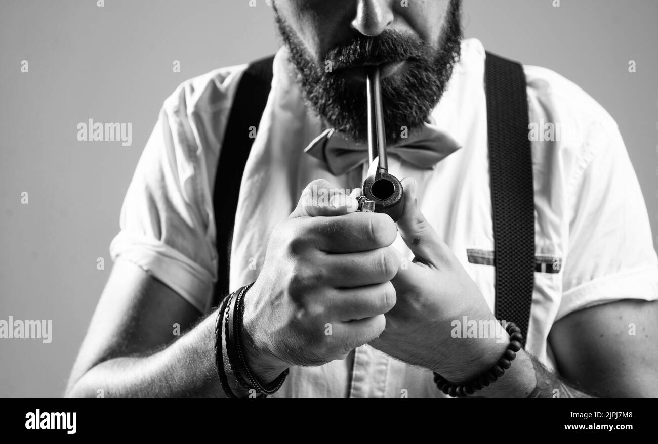 brutal bearded male with stylish look smoking pipe, smoker Stock Photo ...