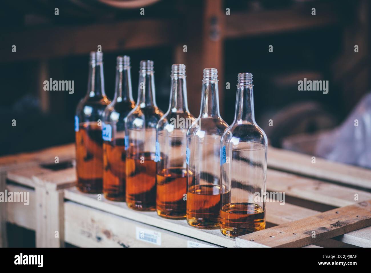 whiskey bottles with descending levels of fullness Stock Photo - Alamy