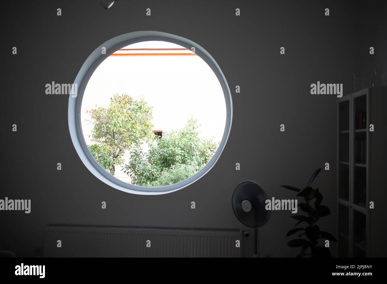 round window tree and house Stock Photo - Alamy