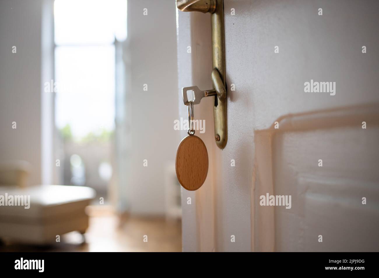 key opening white door to a modern home Stock Photo - Alamy