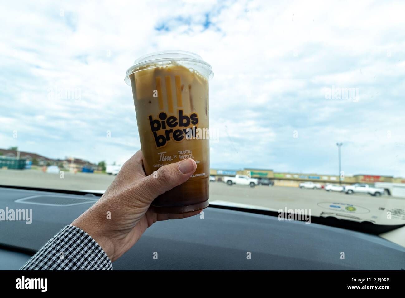 Pincher Creek, Alberta - July 6, 2022: Hand holds up a Biebs Brew iced ...
