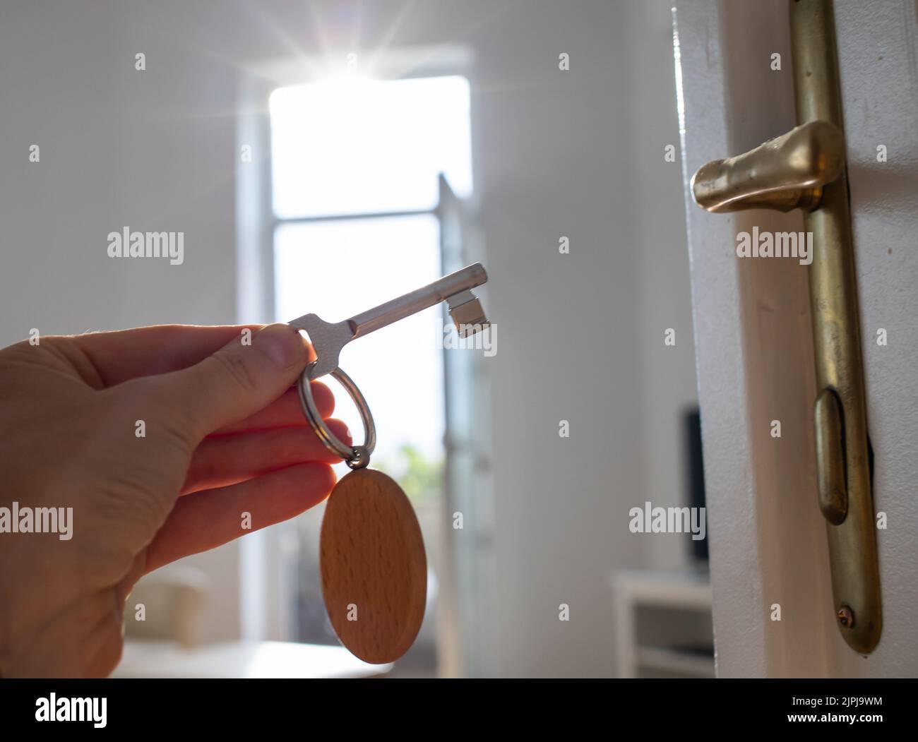 key opening white door to a modern home Stock Photo - Alamy