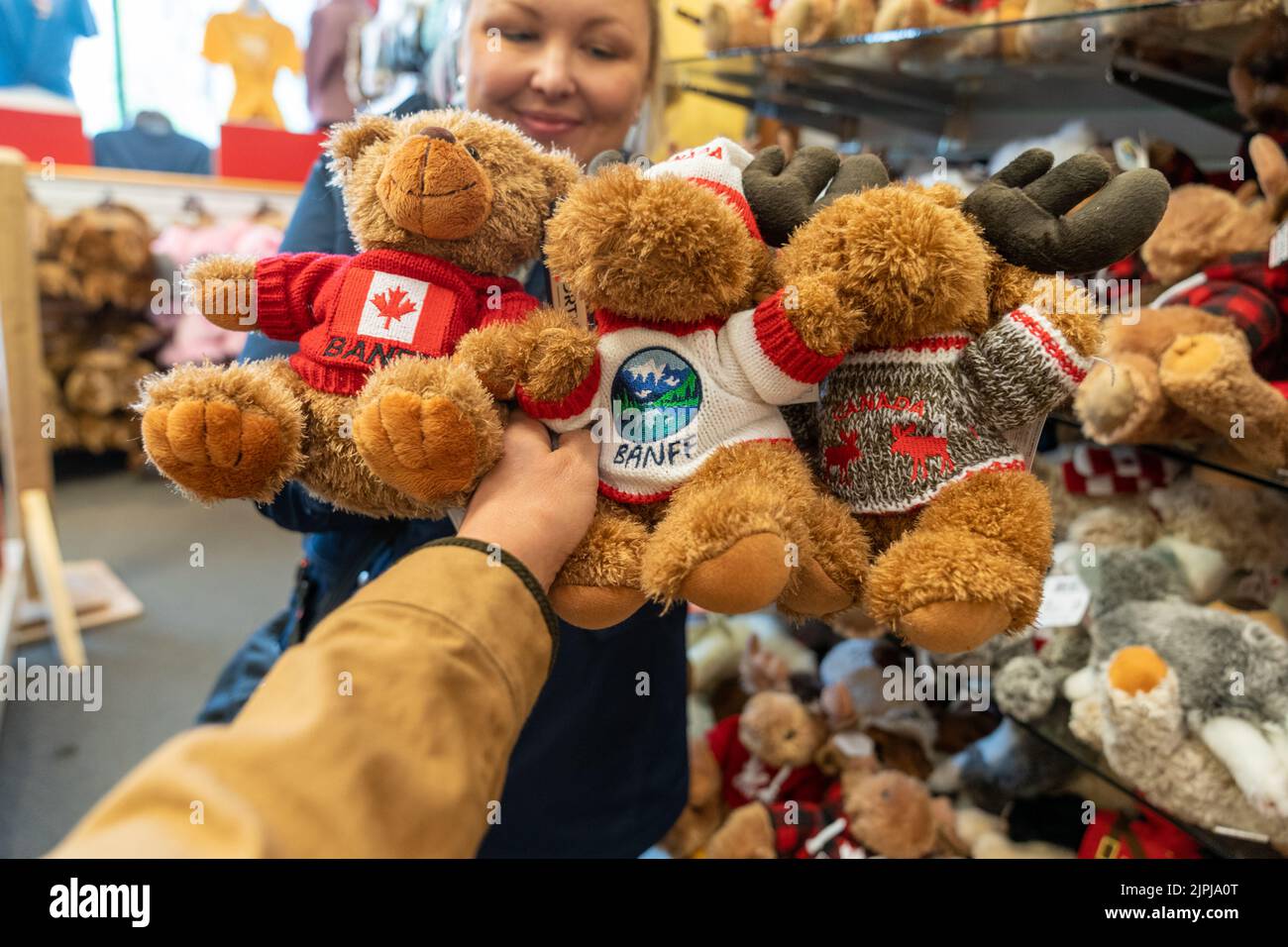Banff, Alberta - July 6, 2022: Two woman shopping hold up a bunch of ...