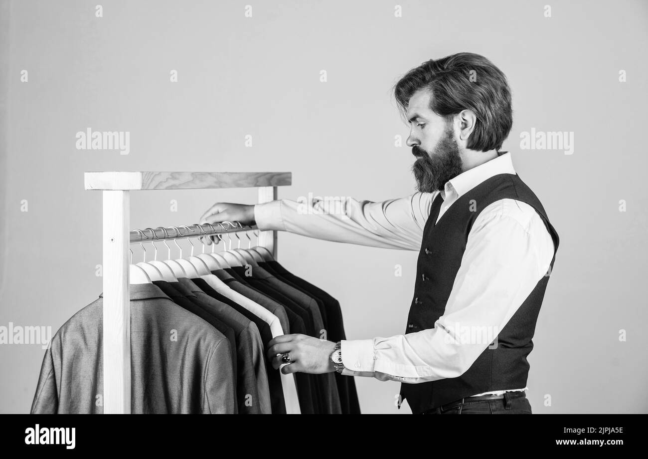 Shopper hipster man in fitting room menswear store, choosing clothes ...