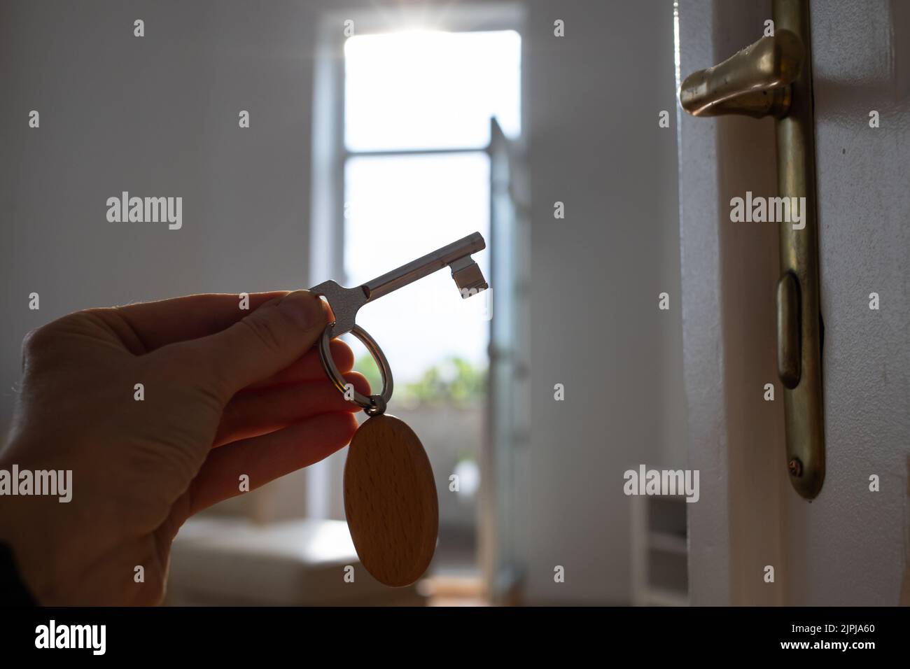 key opening white door to a modern home Stock Photo - Alamy