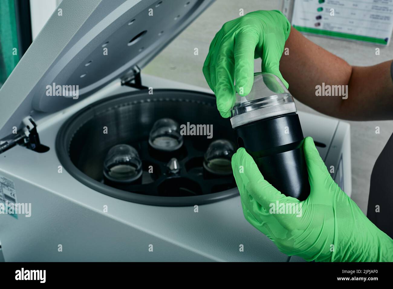 Laboratory scientist placing blood test tubes into centrifuge. Research ... Laboratory scientist placing blood test tubes into centrifuge. Research ...