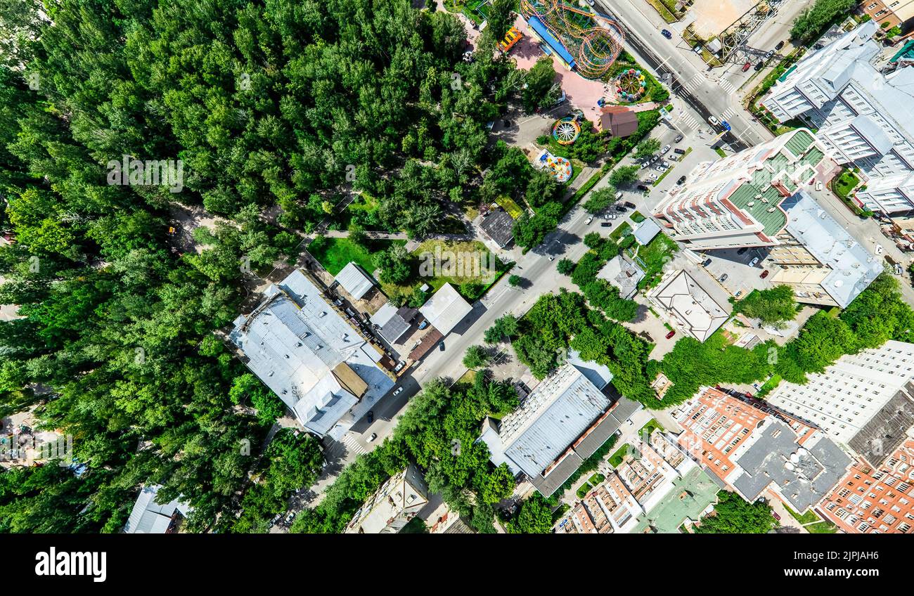 Aerial city view with crossroads and roads, houses, buildings, parks ...