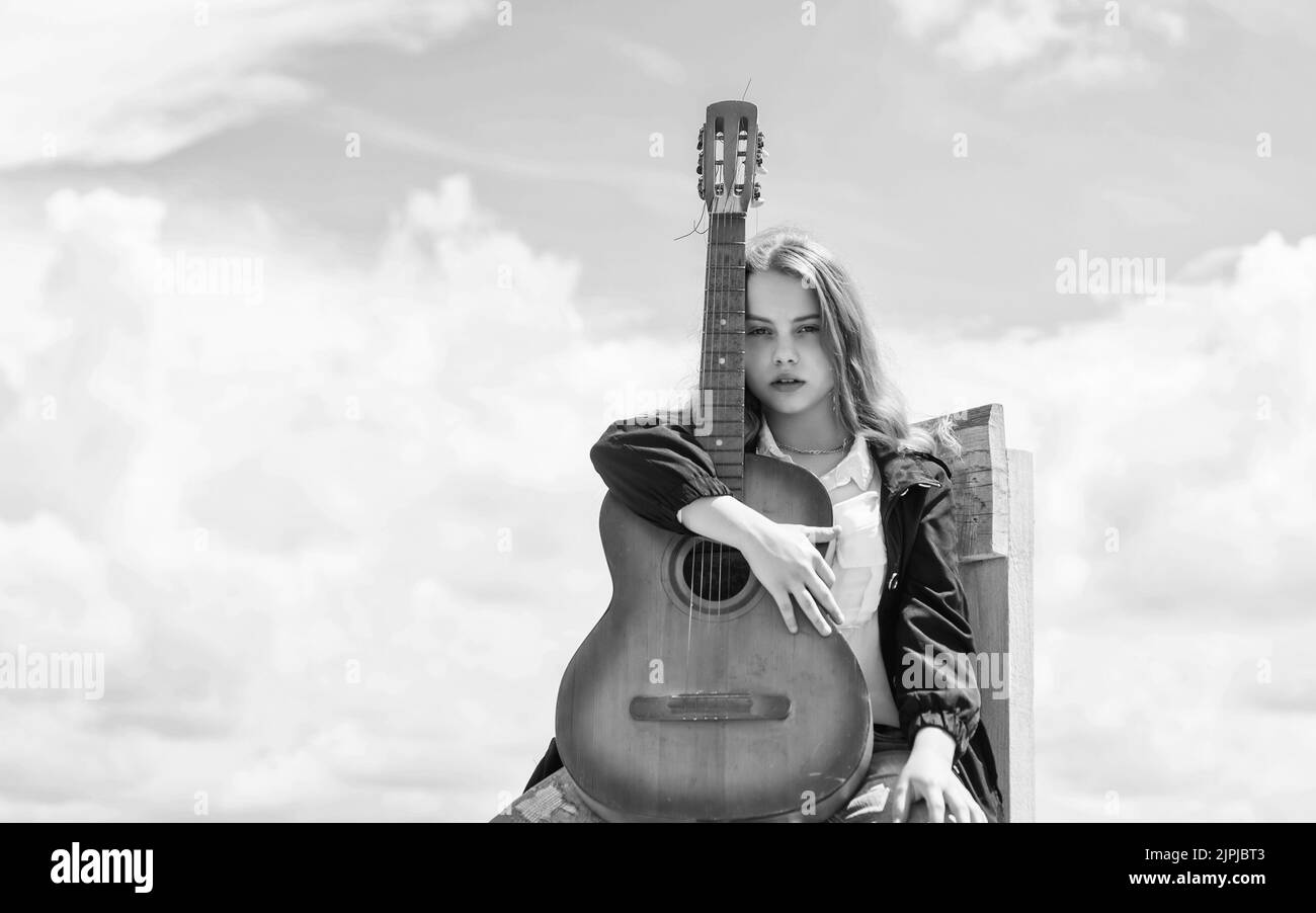 cute kid with acoustic guitar outdoor, music Stock Photo - Alamy