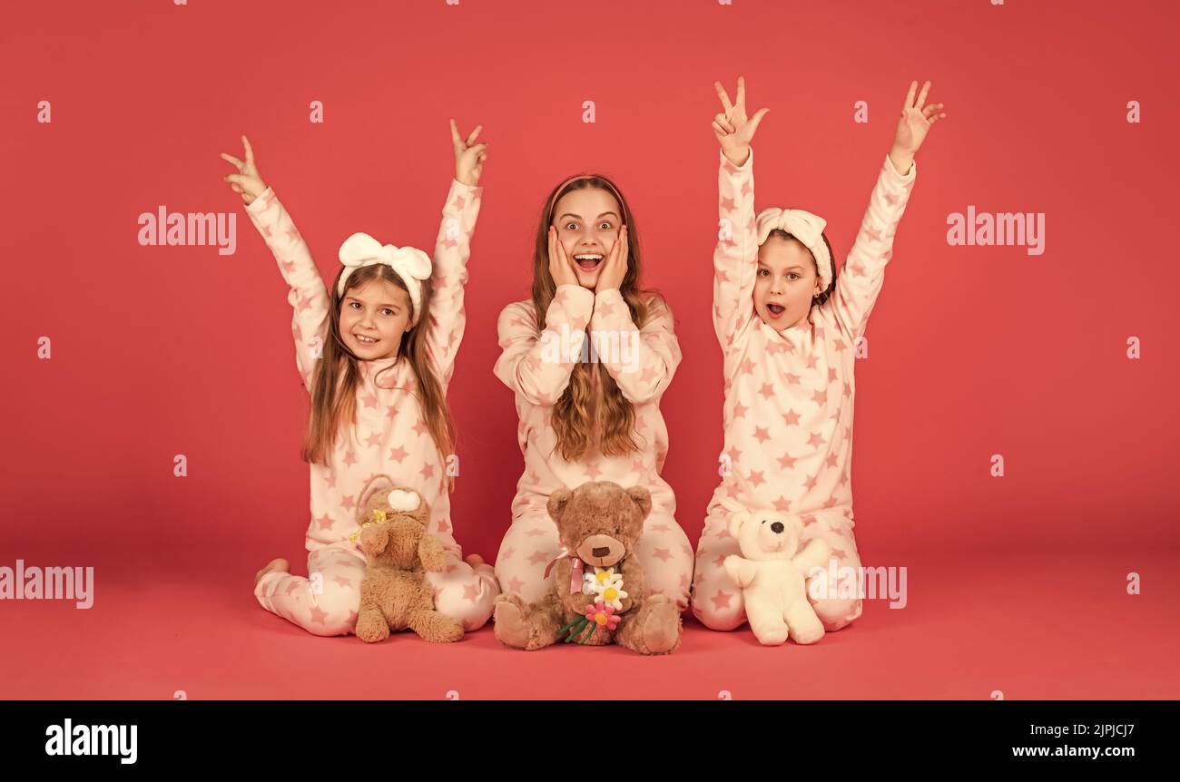Wear pyjamas to celebrate. Surprised girls give v-signs in pyjamas ...