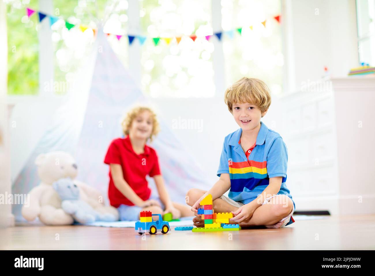 Kids room with teepee tent. Children play in white sunny bedroom. Cozy ...