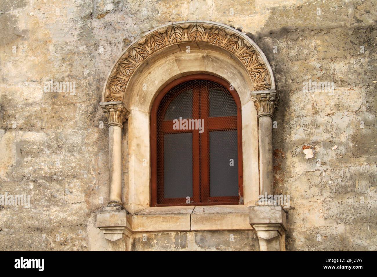 Carovigno, Italy. Beautiful craftsmanship on an arched window of the ...