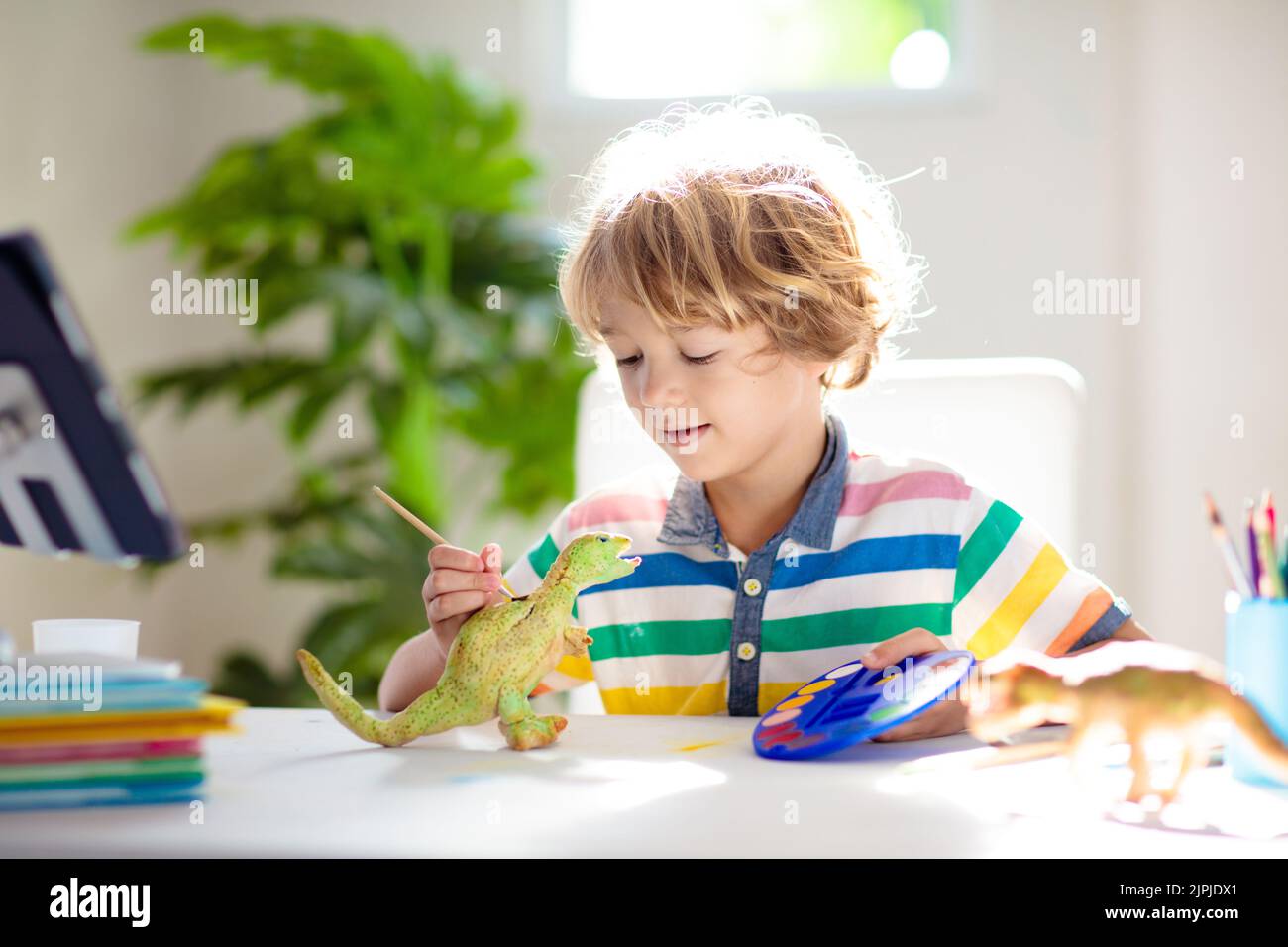 Online remote learning. School kids with computer having video ...