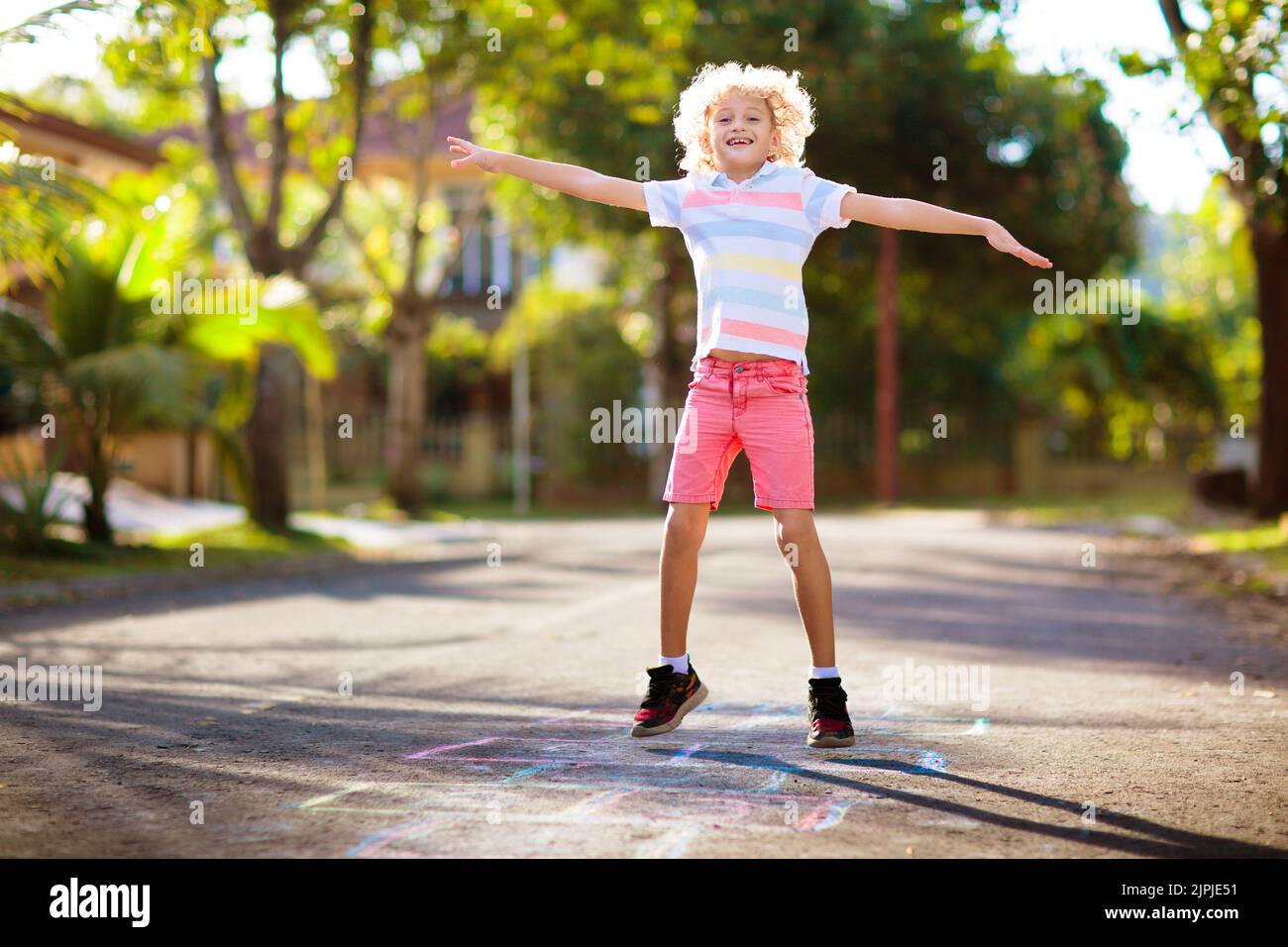 Kids play hopscotch in summer park. Healthy active outdoor game ...