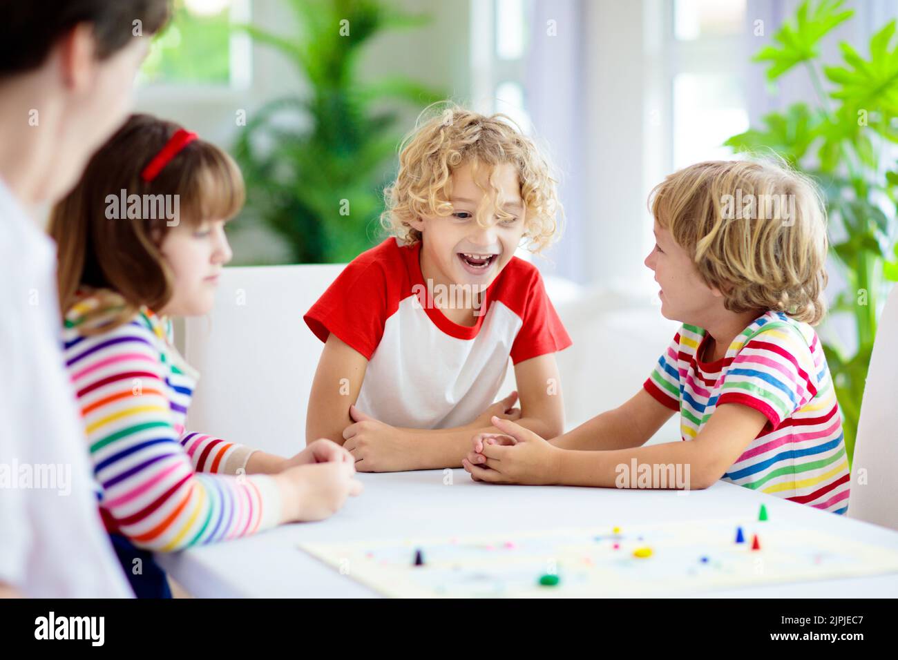 Family playing board game at home. Kids play strategic game. Little boy ...