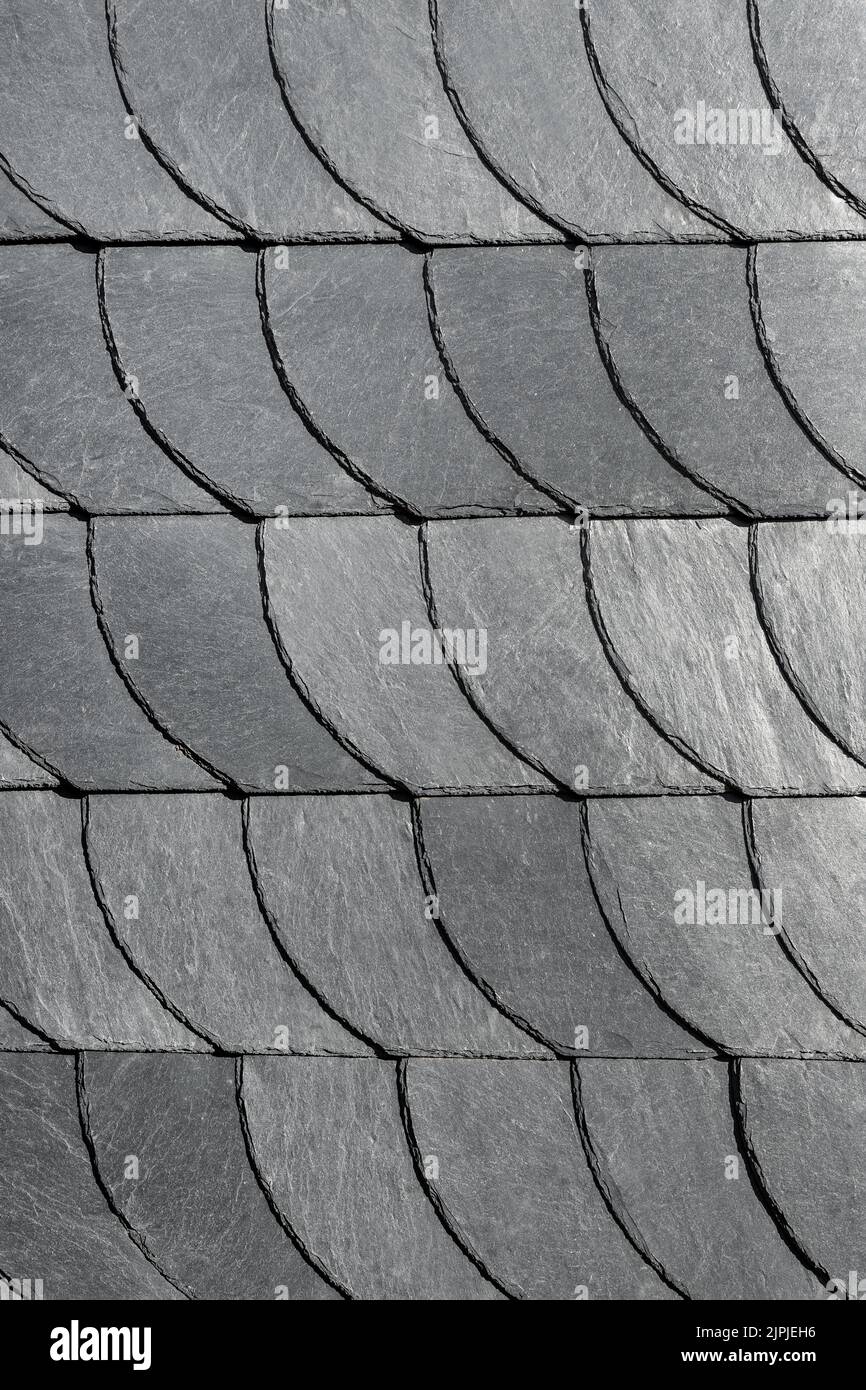 Detail close-up of natural grey stone shingle slate tiles texture roof ...