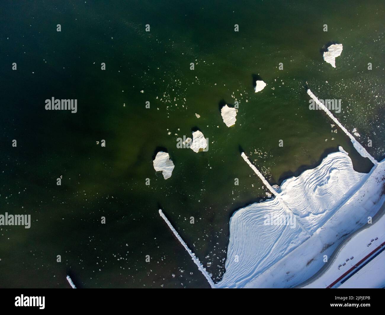 Frozen snowy seacoast with ice floating on seawater Stock Photo - Alamy