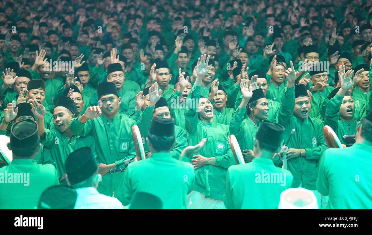 Mass dance and chanting of prayers accompanied by tambourine music from ...