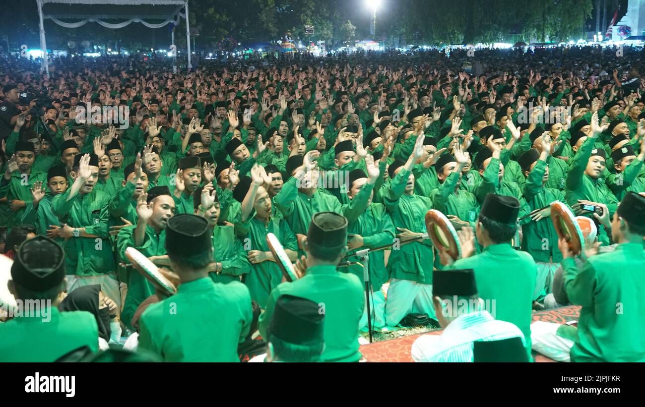 Mass dance and chanting of prayers accompanied by tambourine music from ...