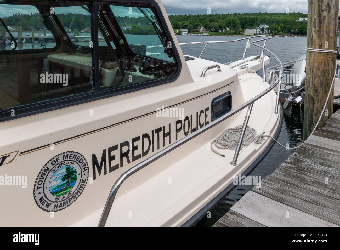A Meredith, NH police boat is docked on Lake Winnipesaukee Stock Photo ...