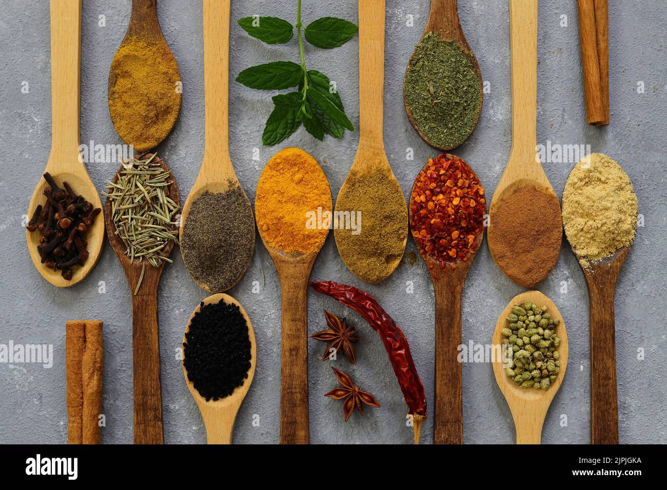 Different kind of spices on a wood background. Big set of Indian spices ...