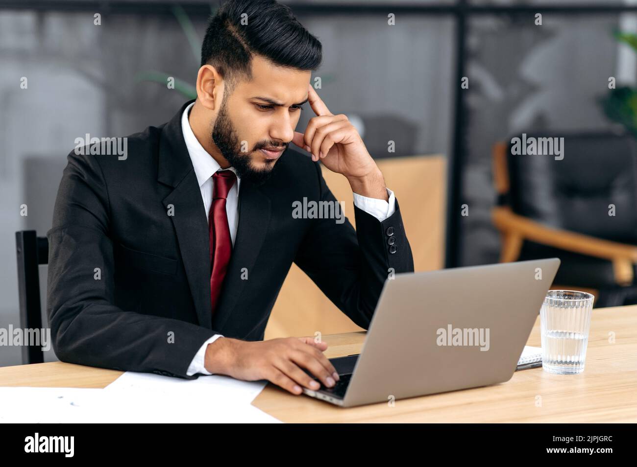 Confused puzzled indian or arabian young businessman, company ceo, in a ...
