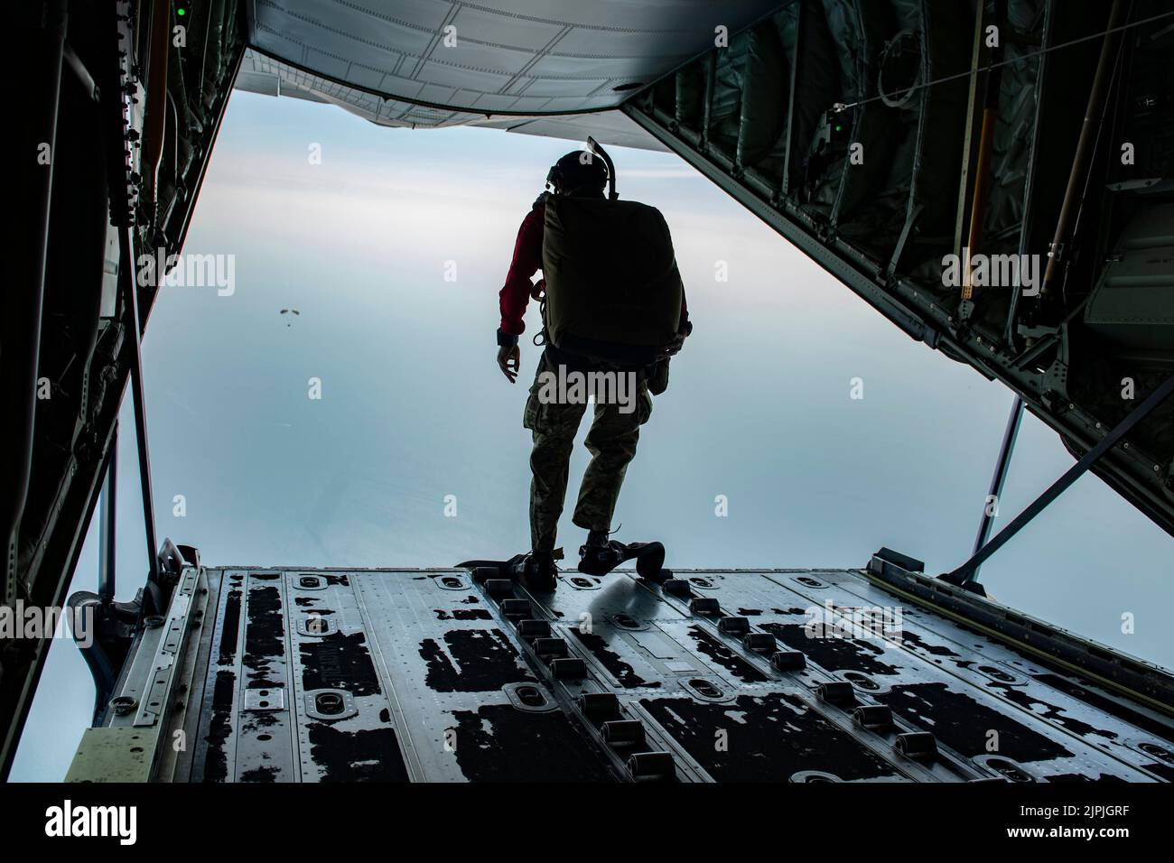 A pararescueman assigned to the 38th Rescue Squadron jump from the back ...
