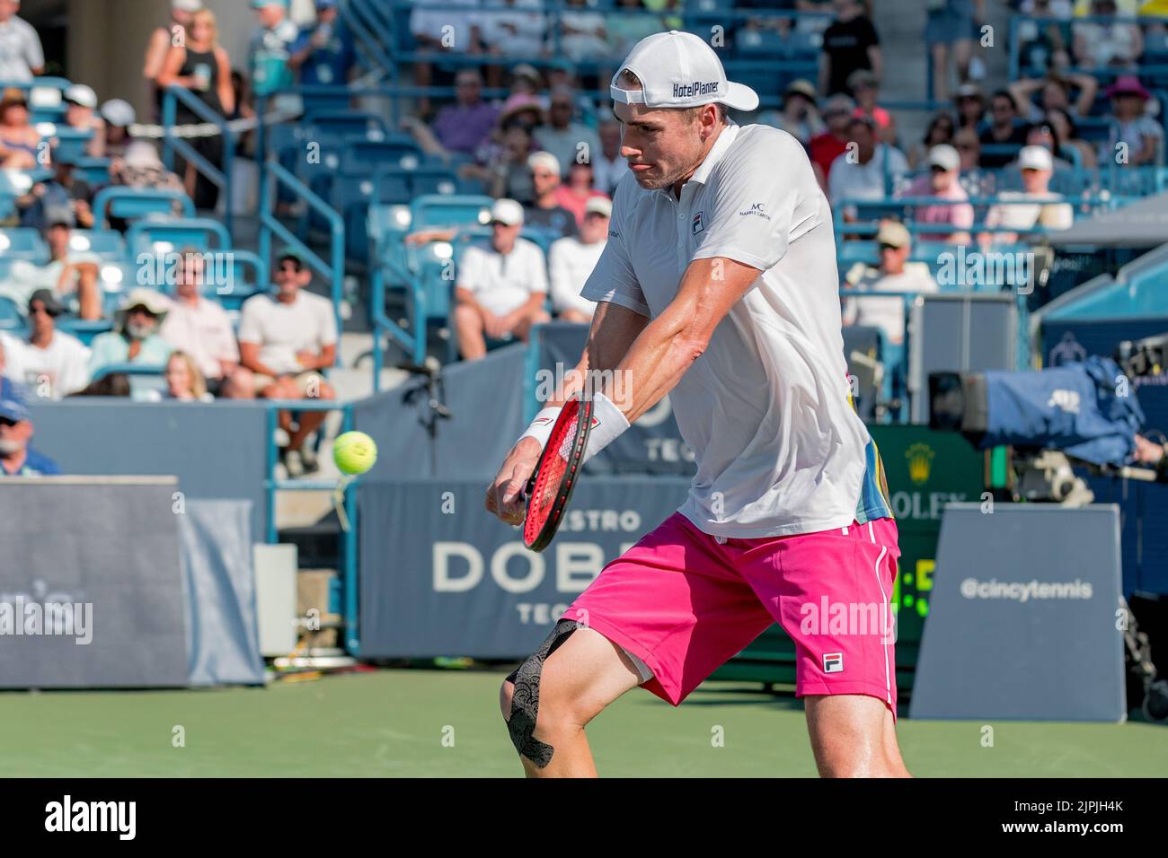 Mason, Ohio, USA. 18th Aug, 2022. John Isner (USA) hits a two-handed ...
