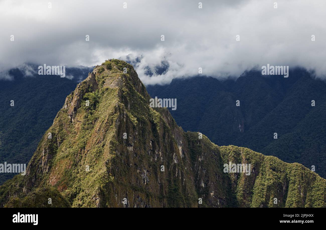 The famous world wonder Inca ruins of Machu Picchu with clouds above ...