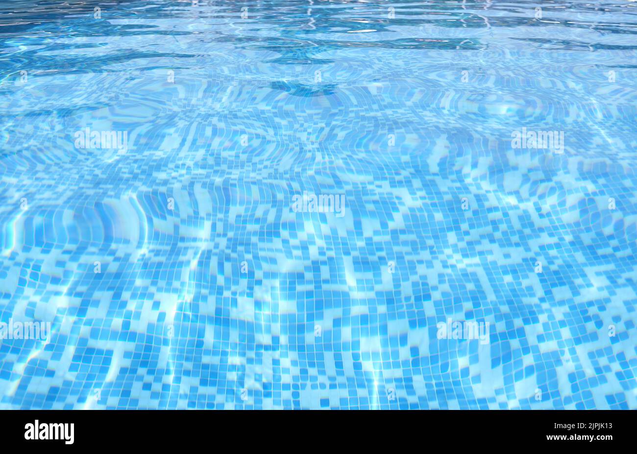 detail of a view of the surface of a swimming pool with a tiled bottom ...