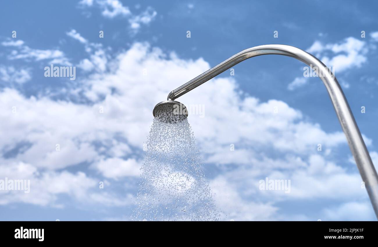 detail of a bottom view of a shower running in a pool with blue sky in ...