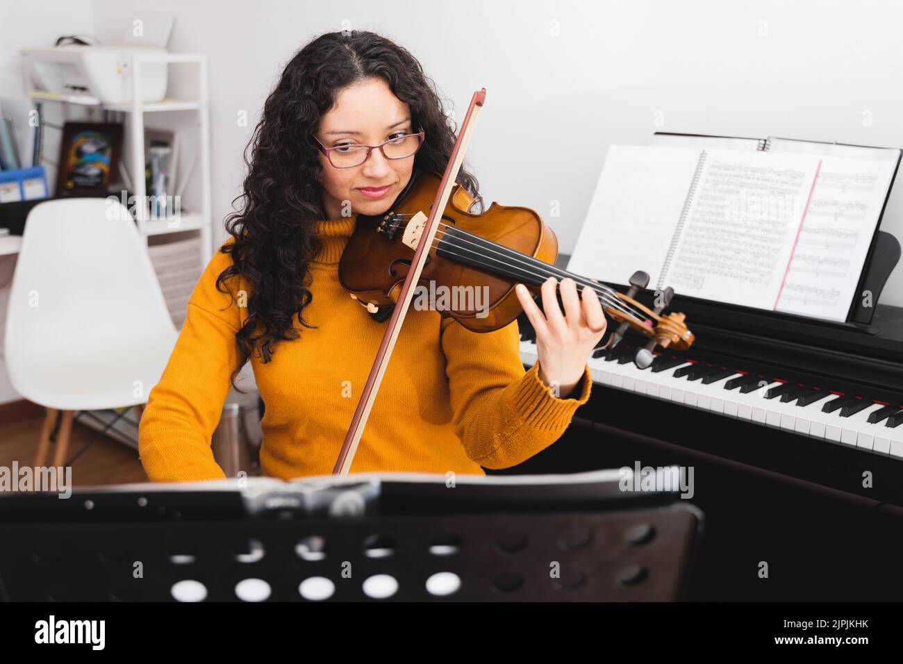 Brunette concert woman wearing a yellow sweater, and playing violin by ...