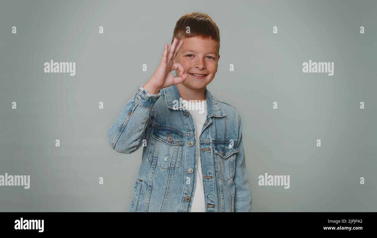 Ok. Toddler kid boy looking approvingly at camera showing ok gesture ...