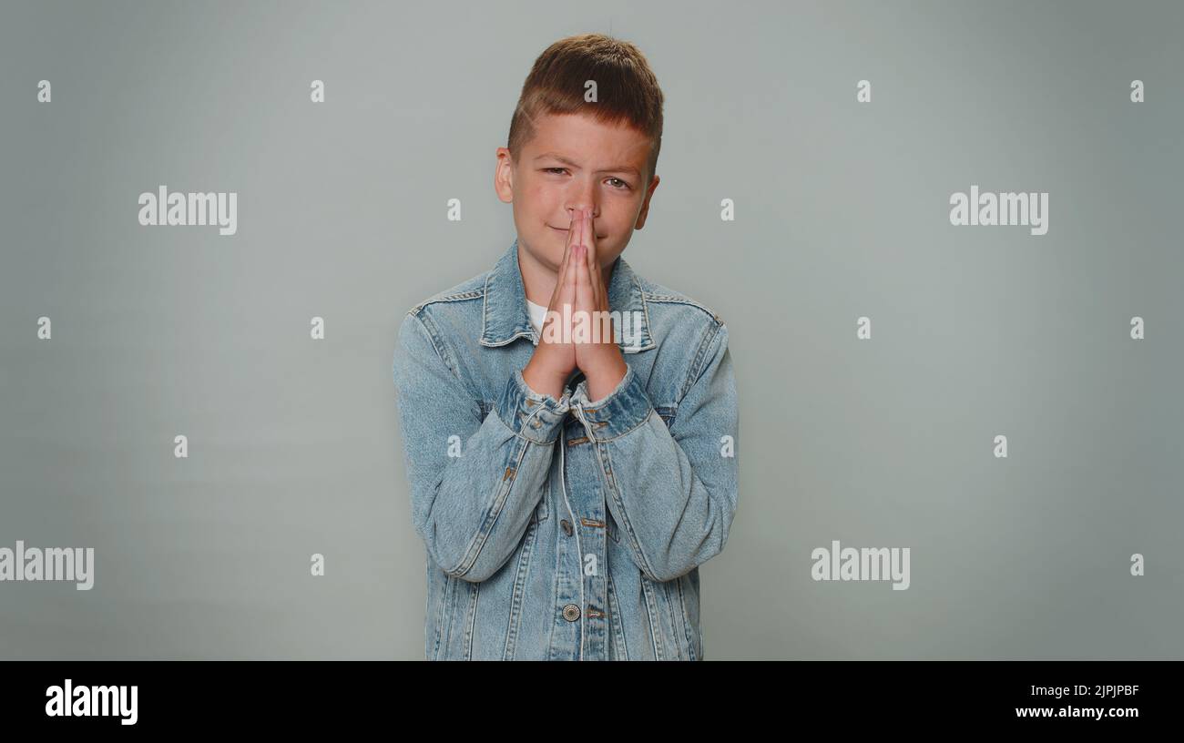 Please, God help me. Toddler boy praying, looking upward, making wish ...