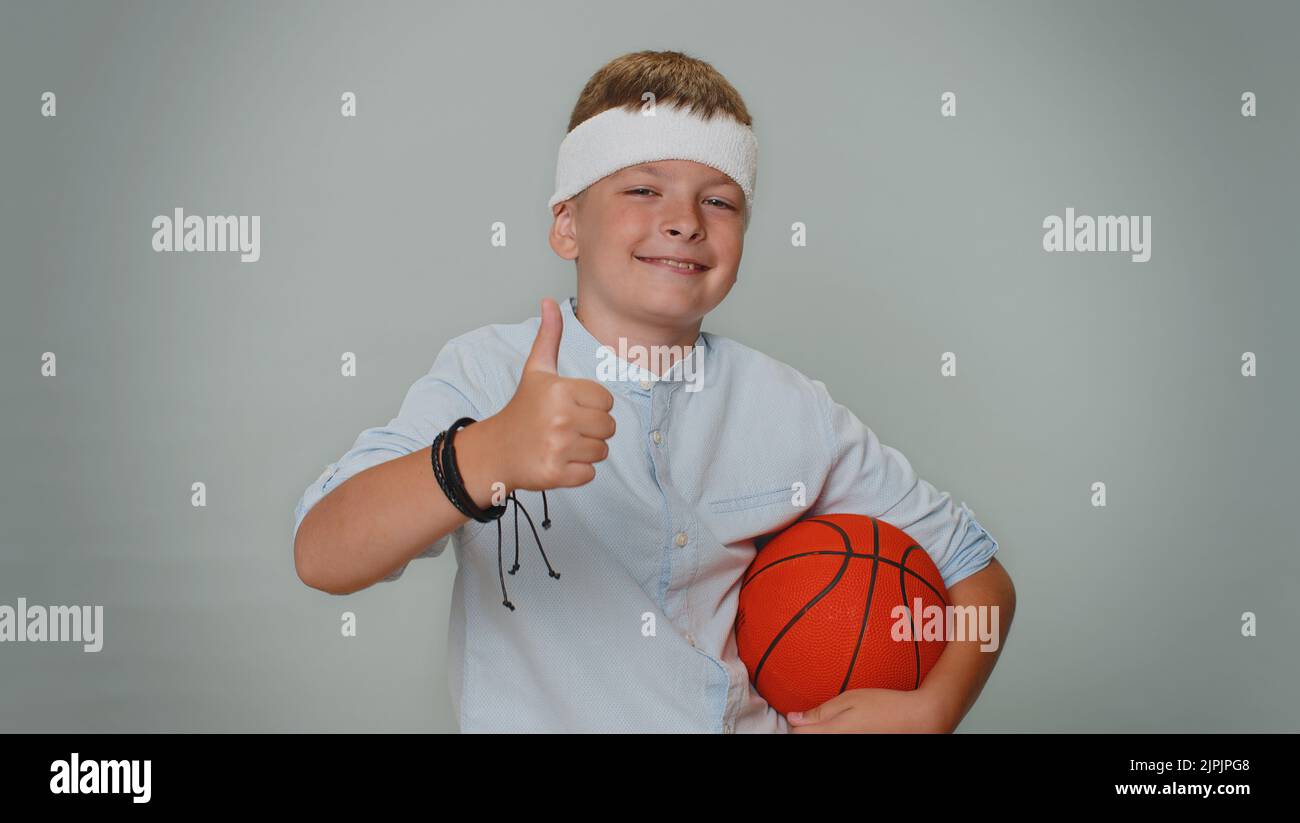 Portrait of toddler kid boy sportsman basketball fan holding ball ...