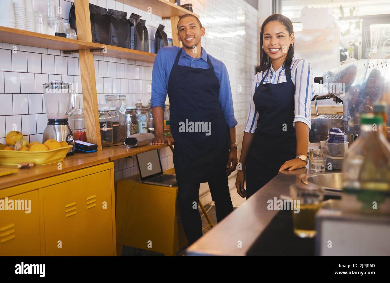 Small business owners or partners standing in a coffee shop together ...