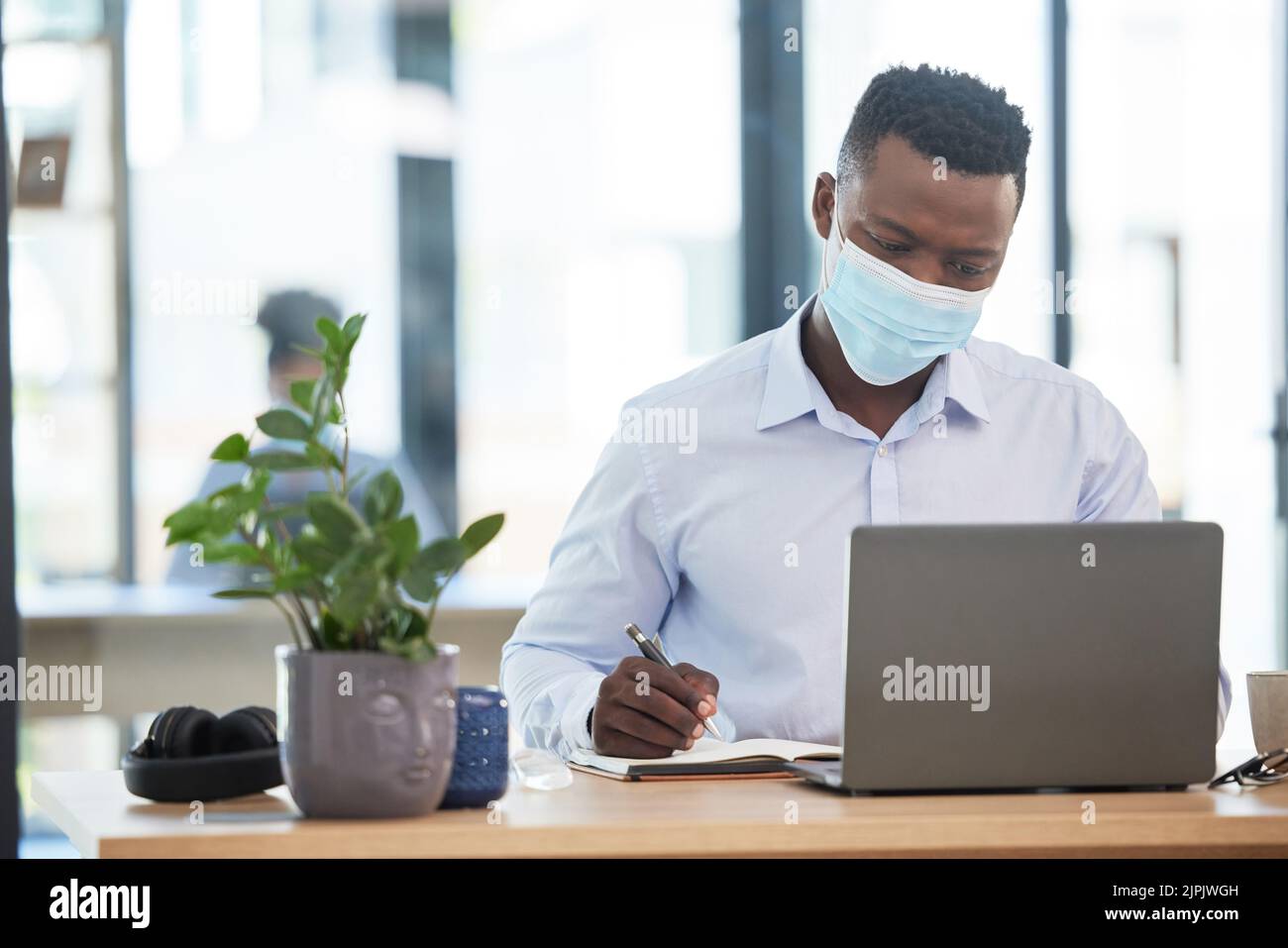 Covid, mask and business man working in quarantine during a pandemic at ...