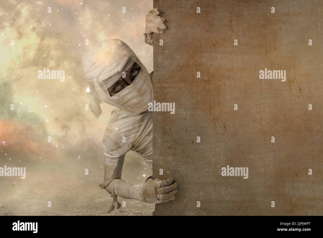 Mummy comes from behind the wall with a fire sparks background ...