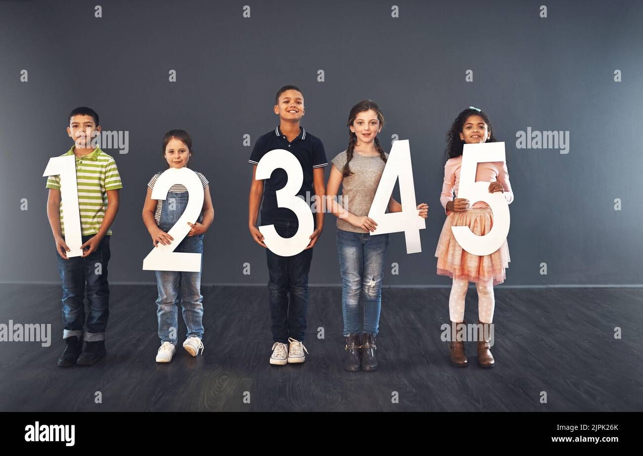 Learning is as easy as 1,2,3. Studio portrait of a diverse group of ...