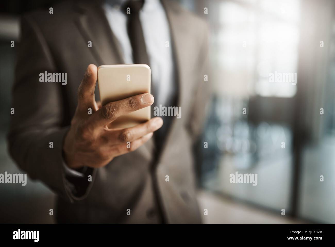 Planning out the day with my cellphone. a businessman using a mobile ...