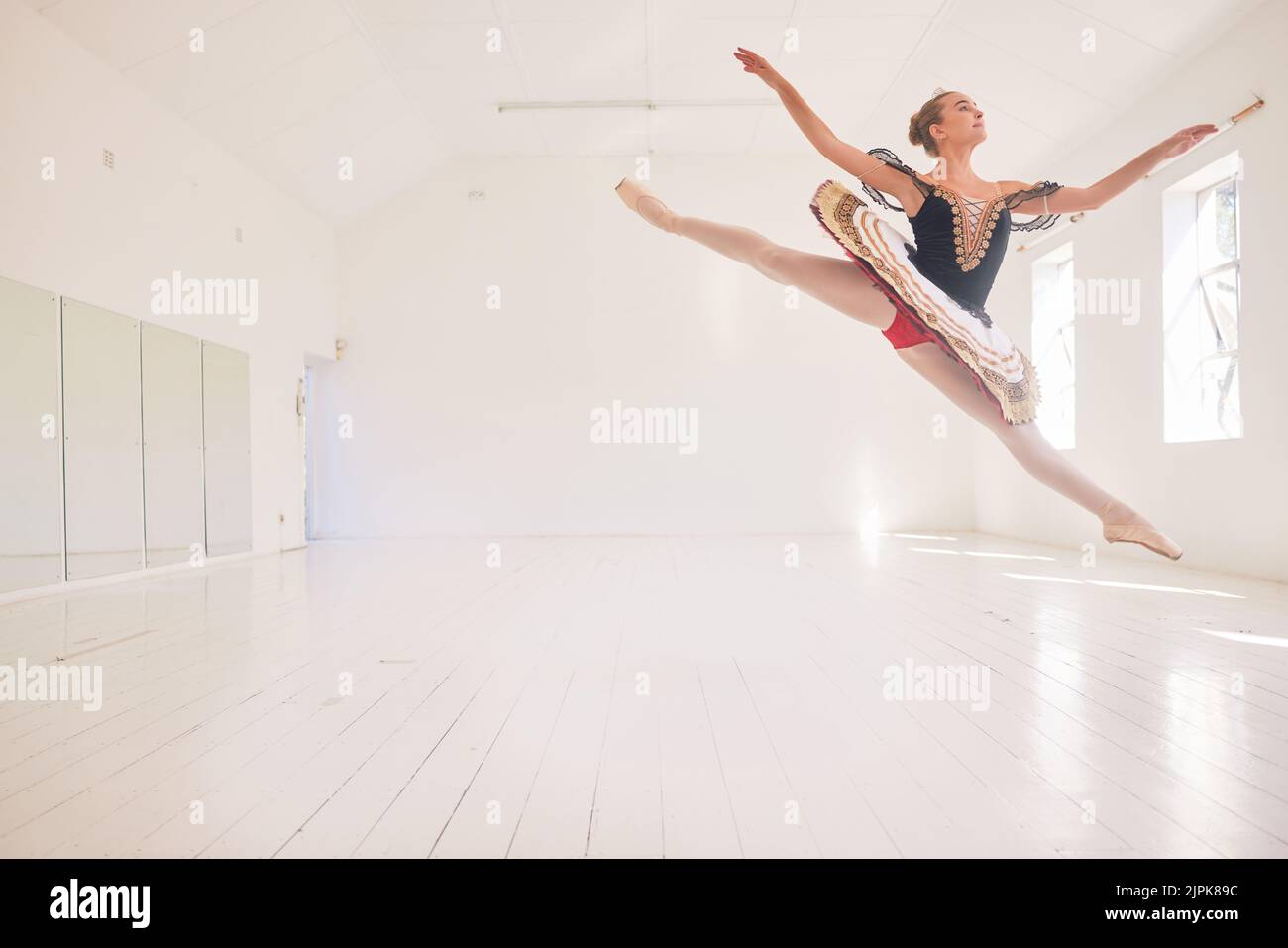 Jumping or leaping female ballerina, ballet dancer or performer in a ...