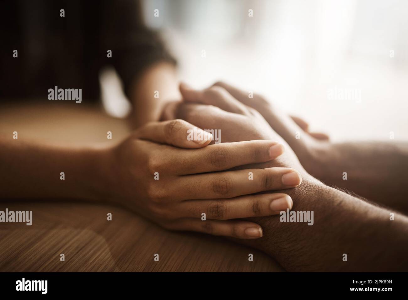 This is a safe place. two unrecognizable people holding hands in ...