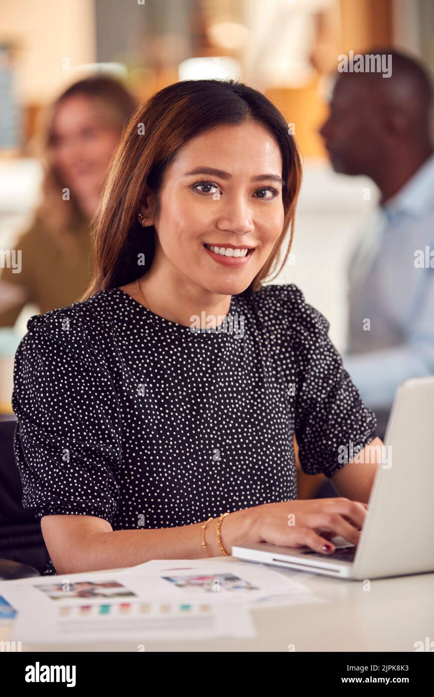 Smiling employees office desks hi-res stock photography and images - Alamy