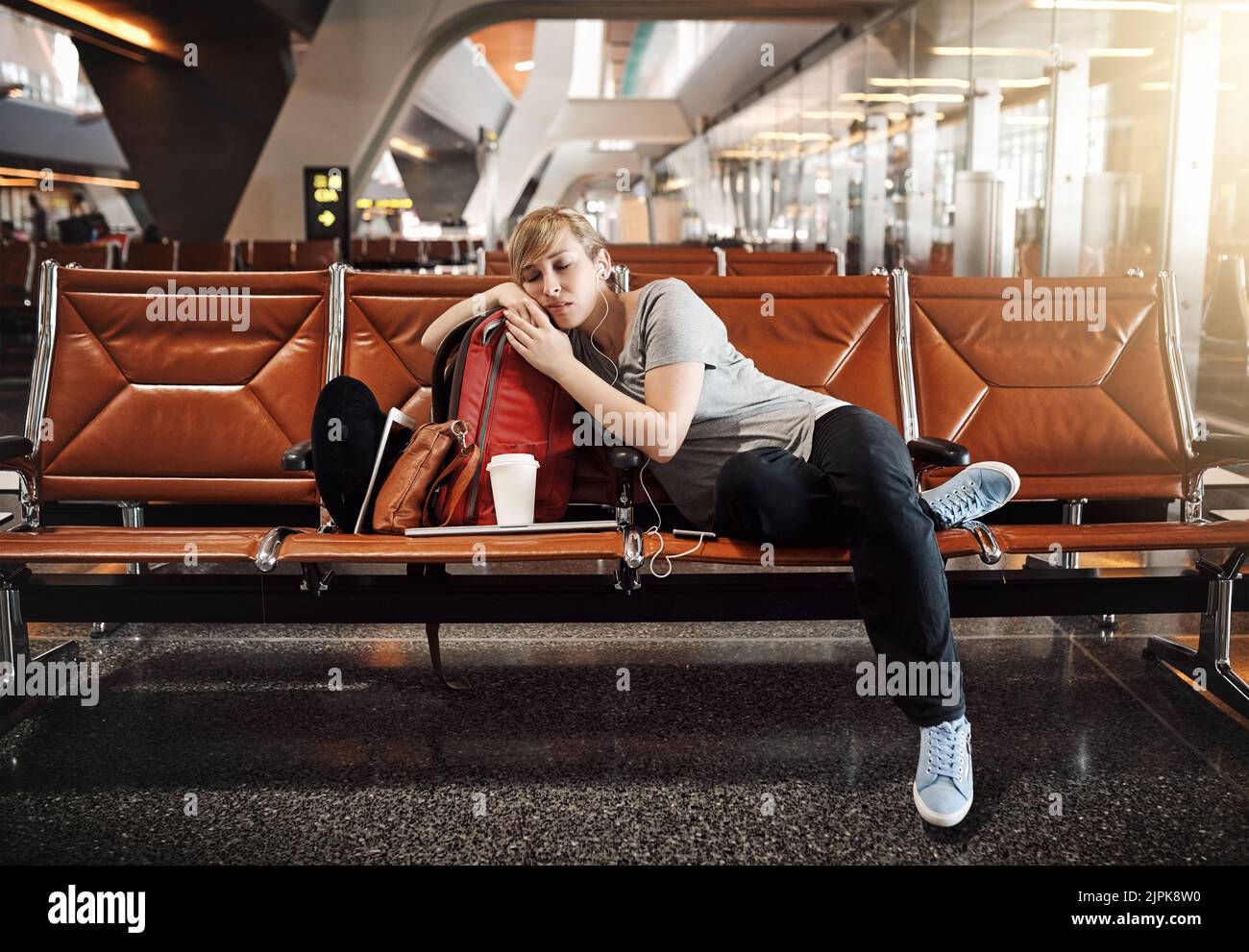 Women sleeping in airport hi-res stock photography and images - Alamy