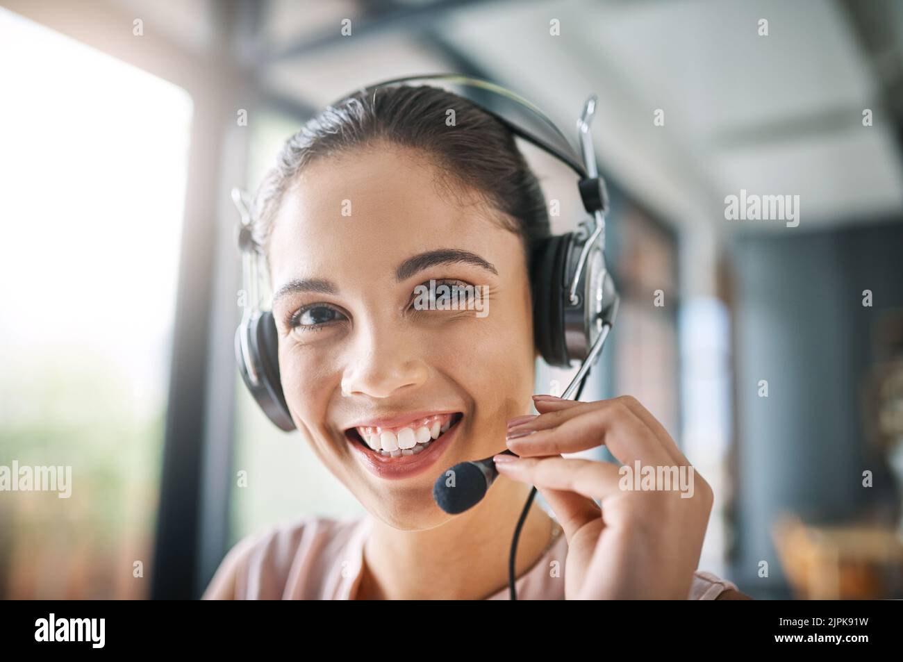 Hello and thank you for calling. Cropped portrait of an attractive ...