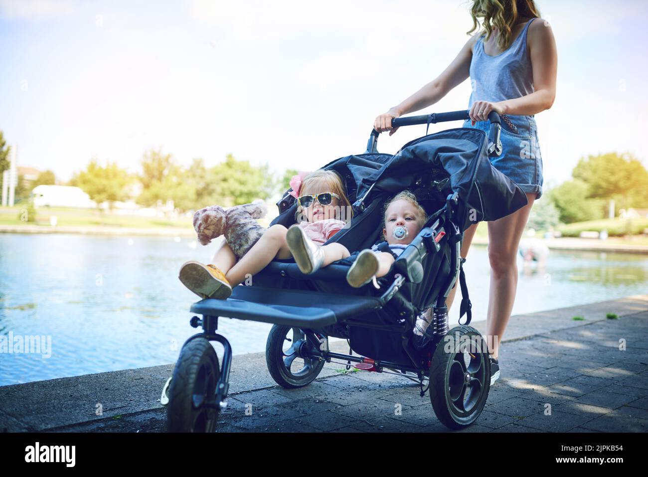 Sightseeing from the view of the stroller. a young woman pushing her ...